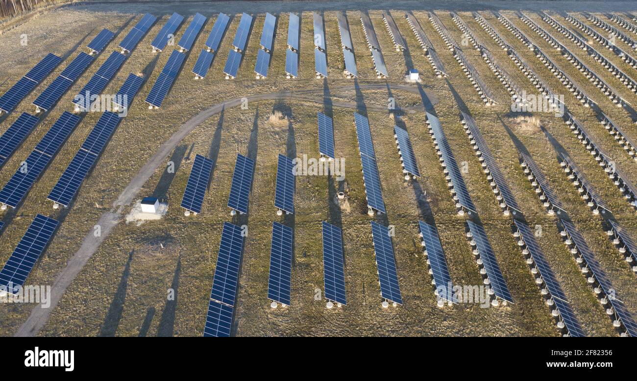 An aerial shot of solar panels in lines in the natural landscape Stock ...