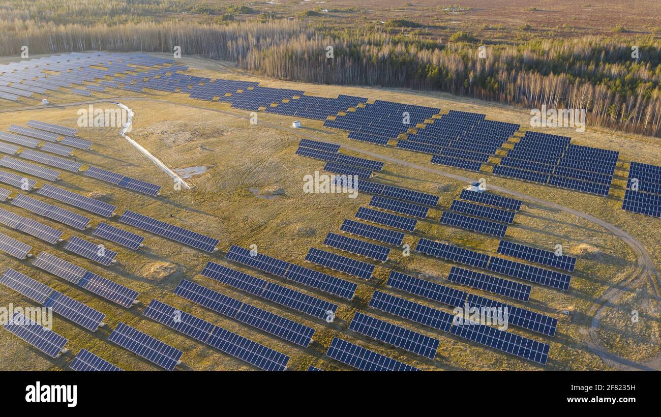 An aerial shot of solar panels in lines in the natural landscape Stock ...