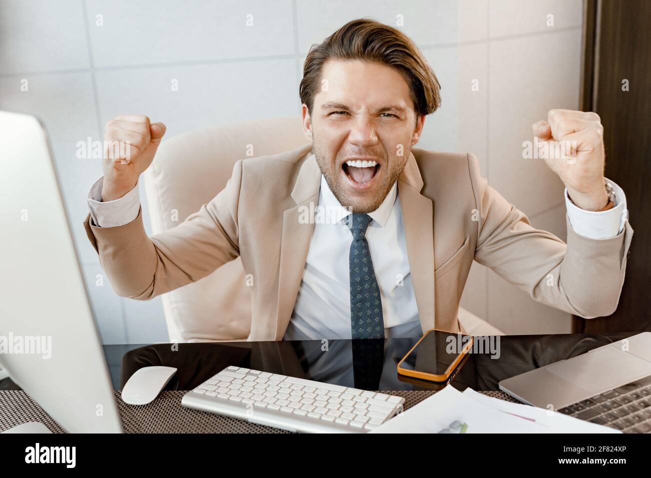 Overjoyed young businessman in suit hi-res stock photography and images ...