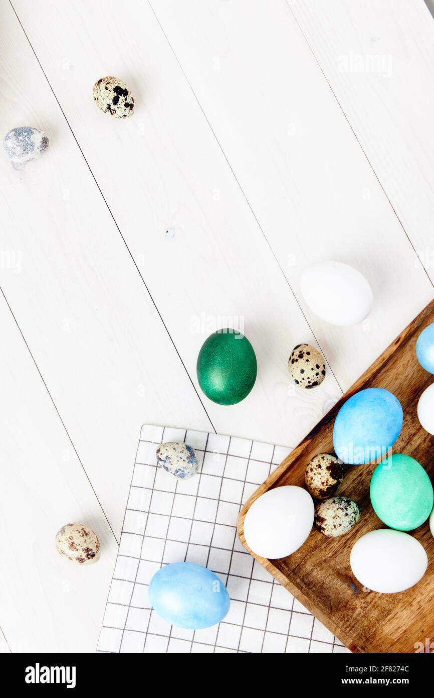 multicolored easter eggs on chalkboard on wooden background top view ...