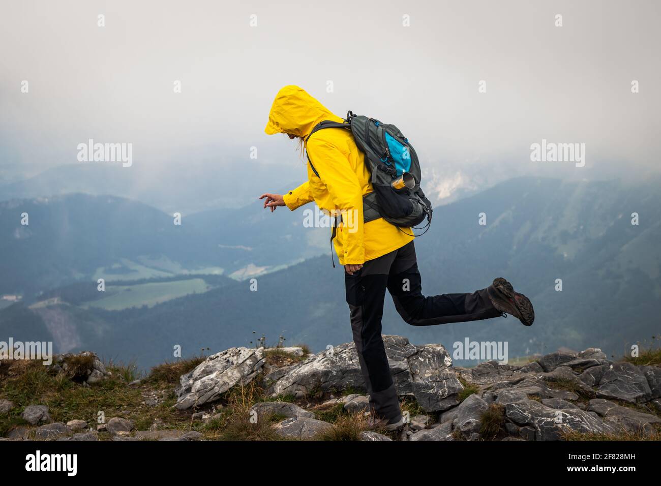 Be careful when hiking in mountain. Woman falling down after slip on ...