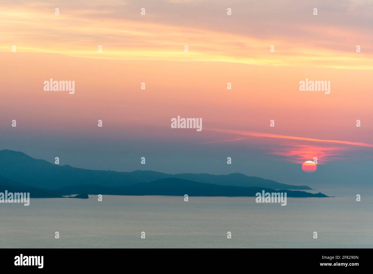 Orange sunset with sun like a ball in Corsica Stock Photo - Alamy