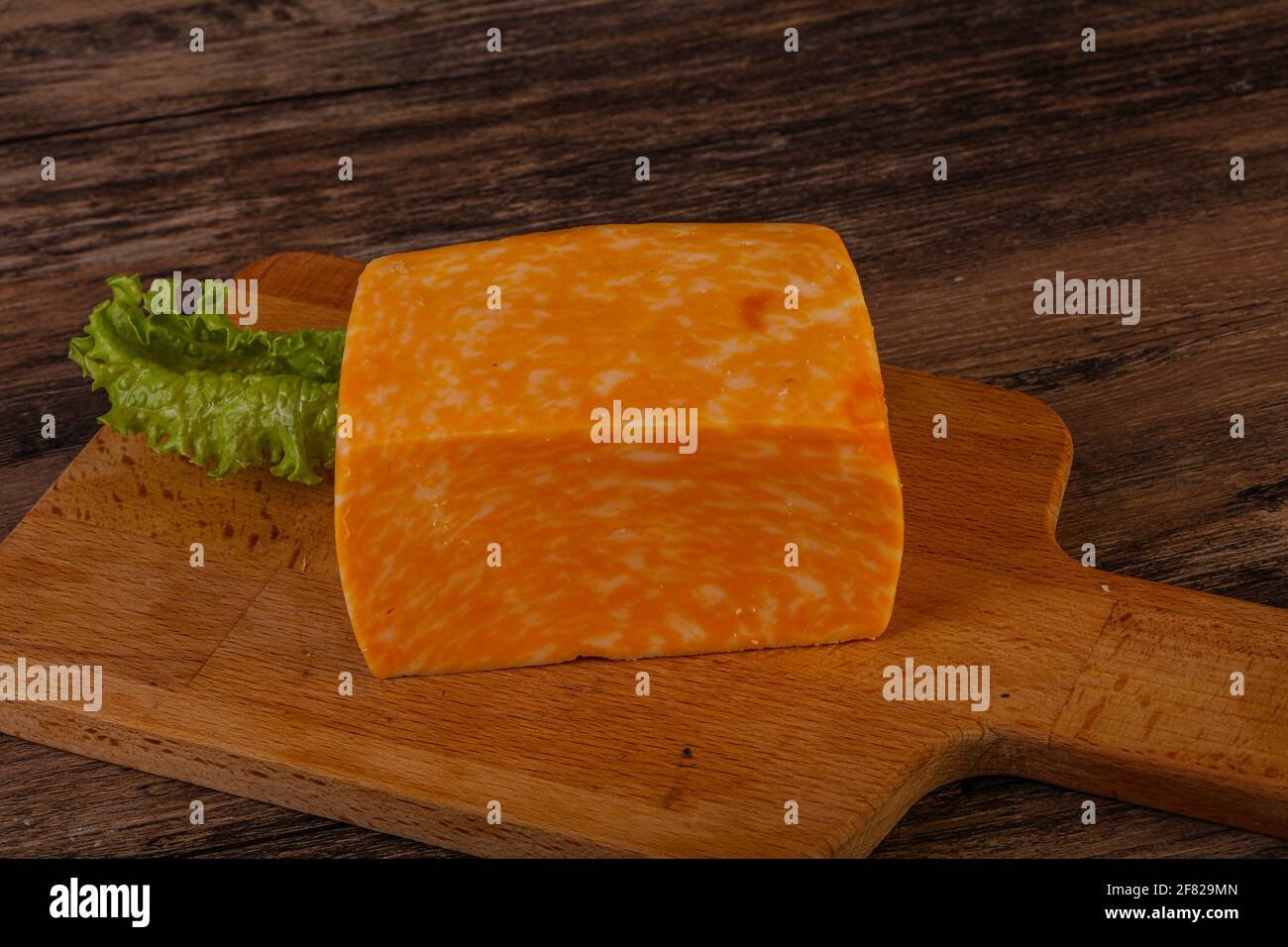 Dairy Marble cheese brick over board Stock Photo - Alamy