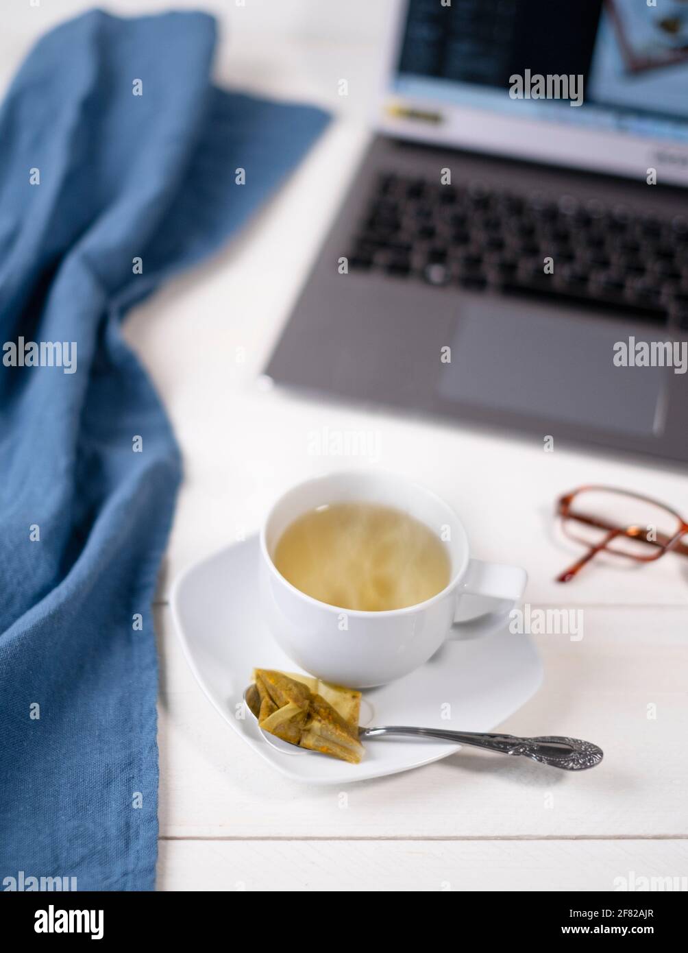 Time out in home office, a hot cup of tea to relax during the break at ...