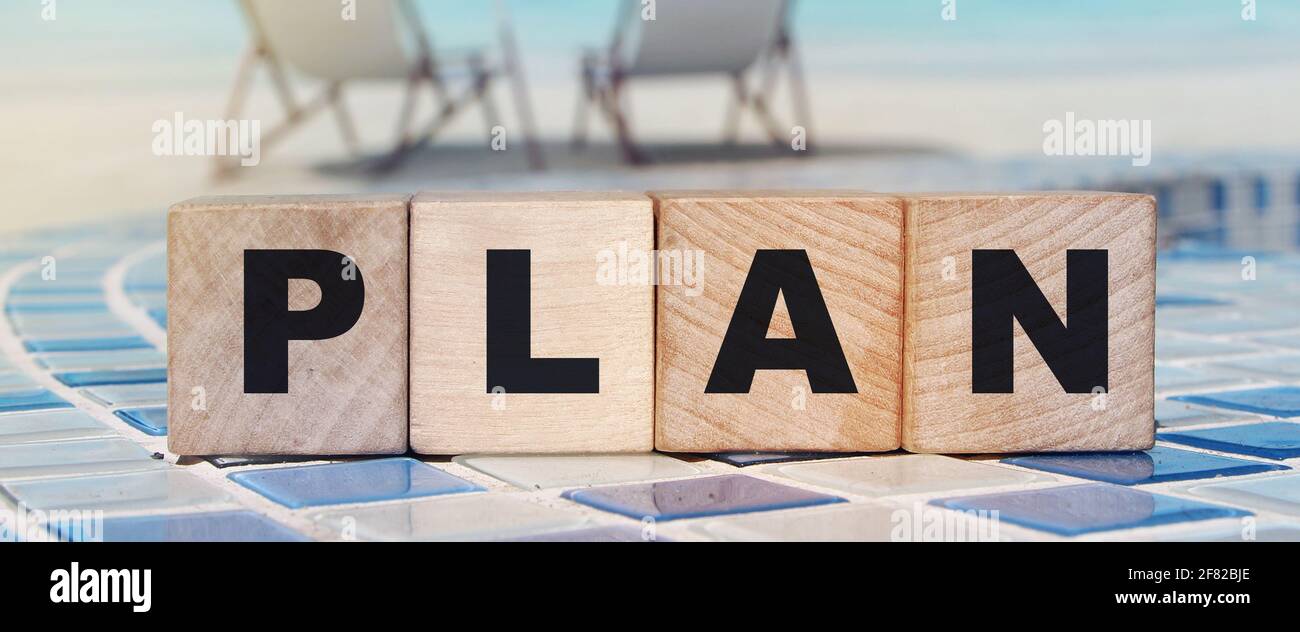 Plan word made with building blocks on relaxed beach background. Sun ...