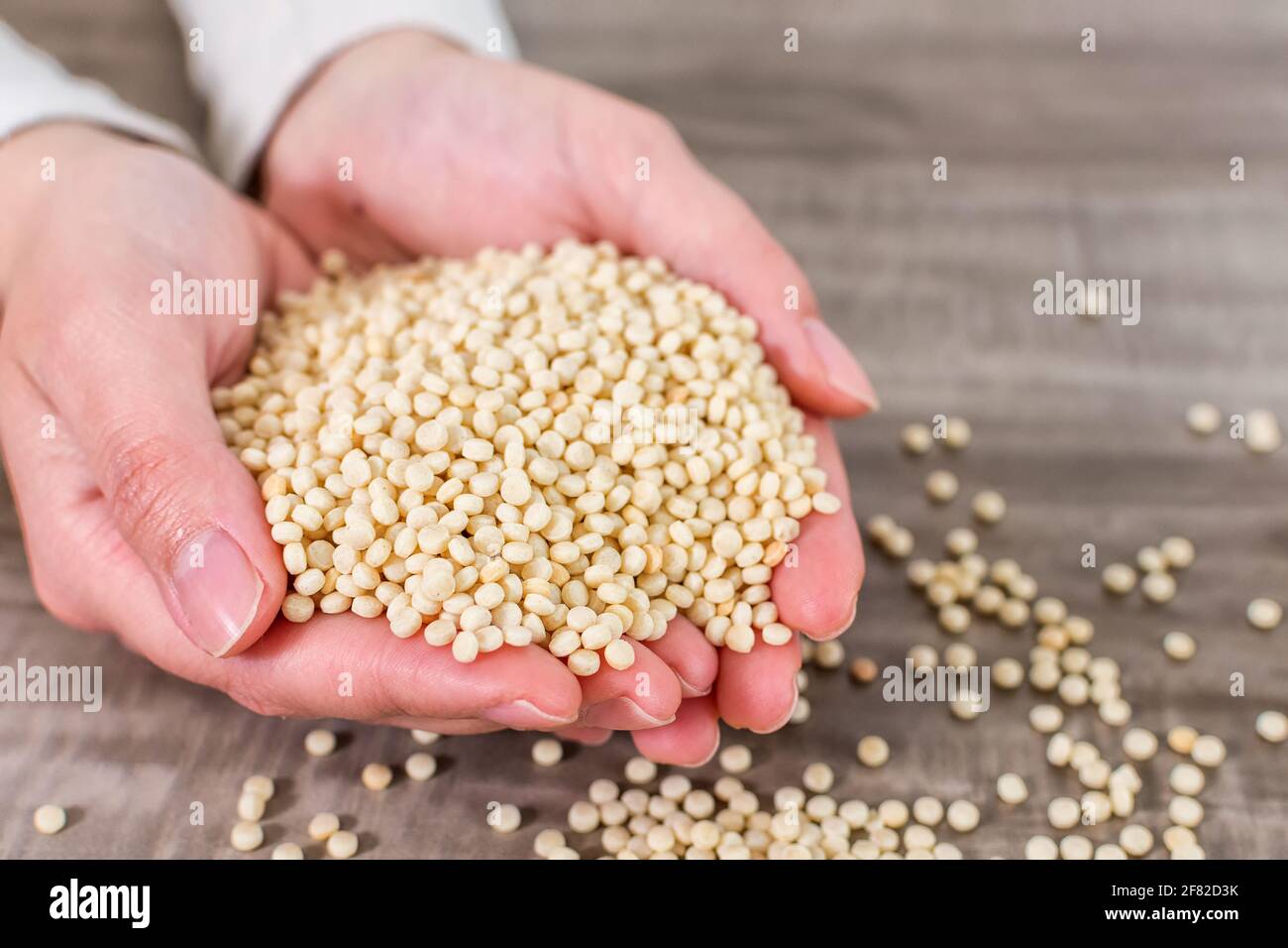 A closeup of hands holding Israeli couscous Stock Photo - Alamy