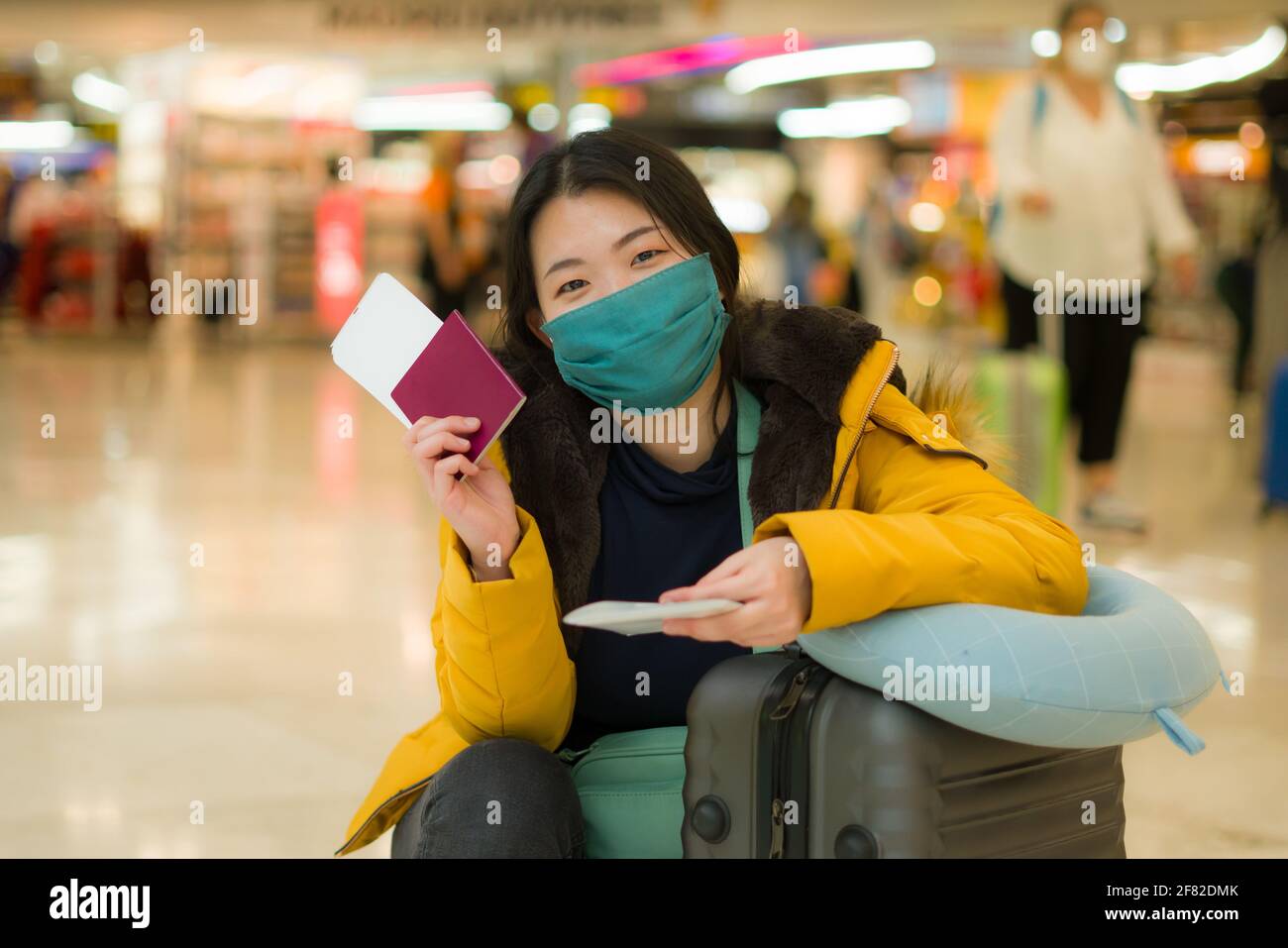 Asian woman flying in covid19 times - lifestyle portrait of young happy ...
