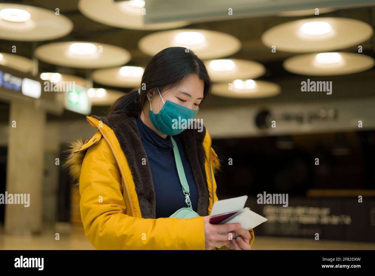 Asian woman flying in covid19 times - lifestyle portrait of young happy ...