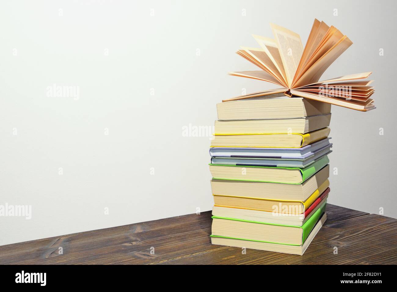 Stack of books on rustic table. Free space for text Stock Photo - Alamy