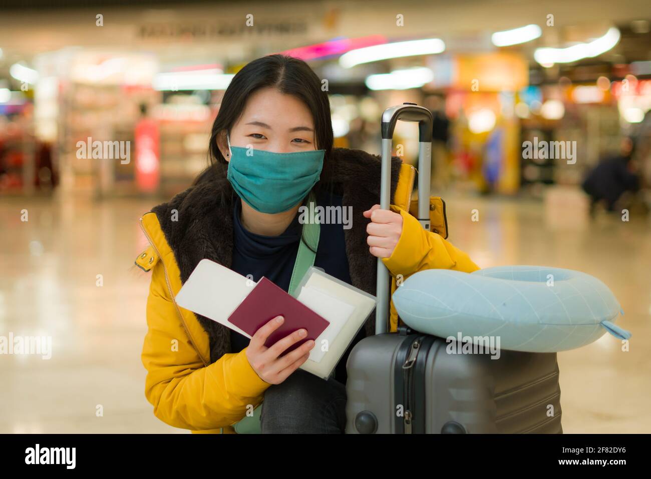 Asian woman flying in covid19 times - lifestyle portrait of young happy ...