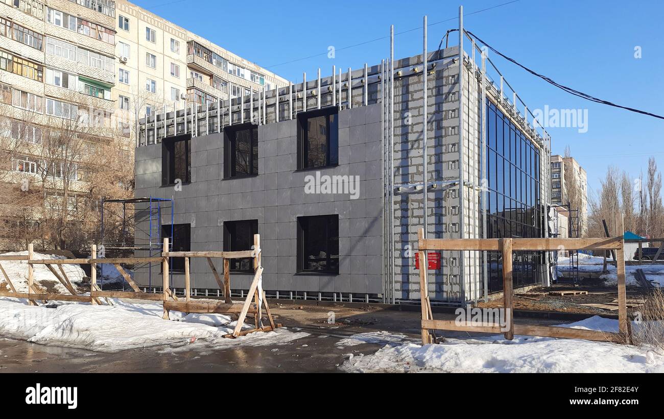 Facing a building under construction with square panels Stock Photo - Alamy