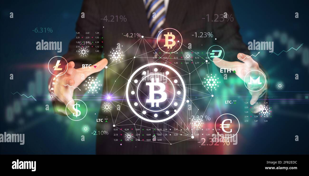 Businessman holding currency symbols concept Stock Photo - Alamy