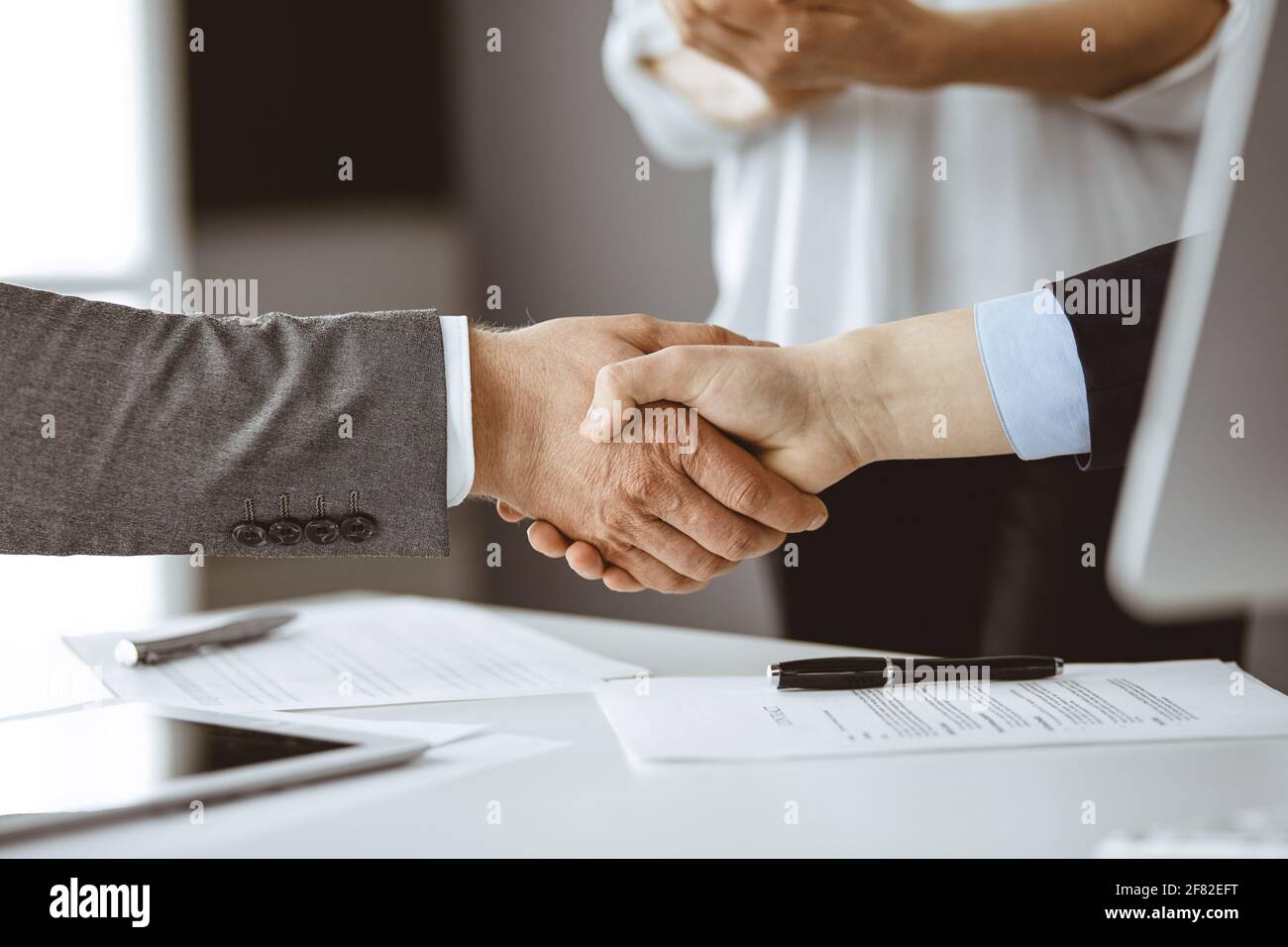 Business people shaking hands finishing contract signing, close-up ...