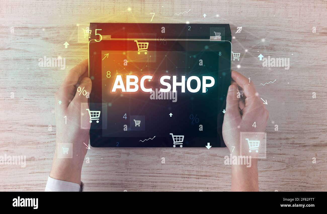 Close-up of a hand holding tablet with shopping inscription Stock Photo ...
