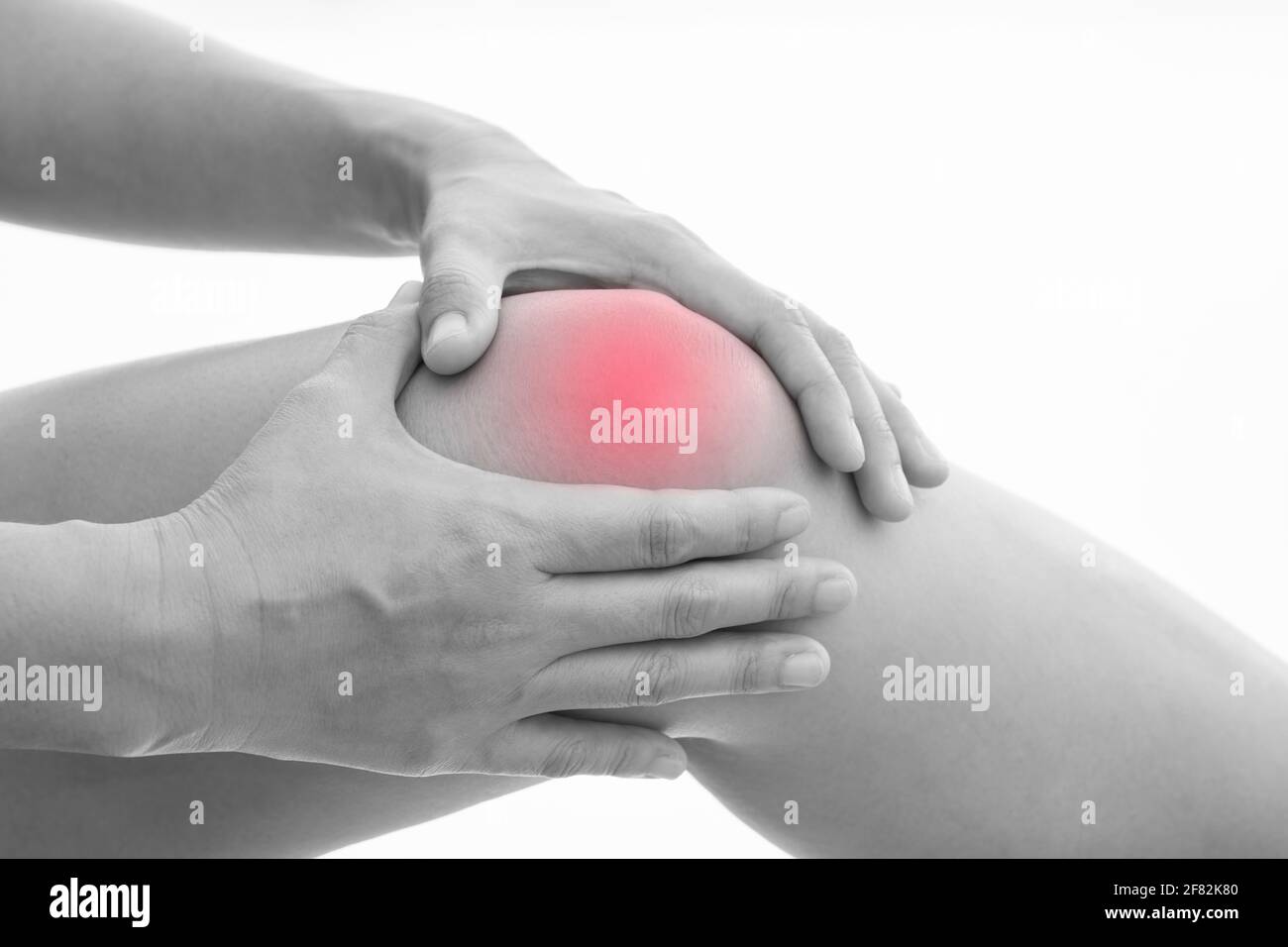 Front view of a young women knee muscle pain. Red around the pain area ...