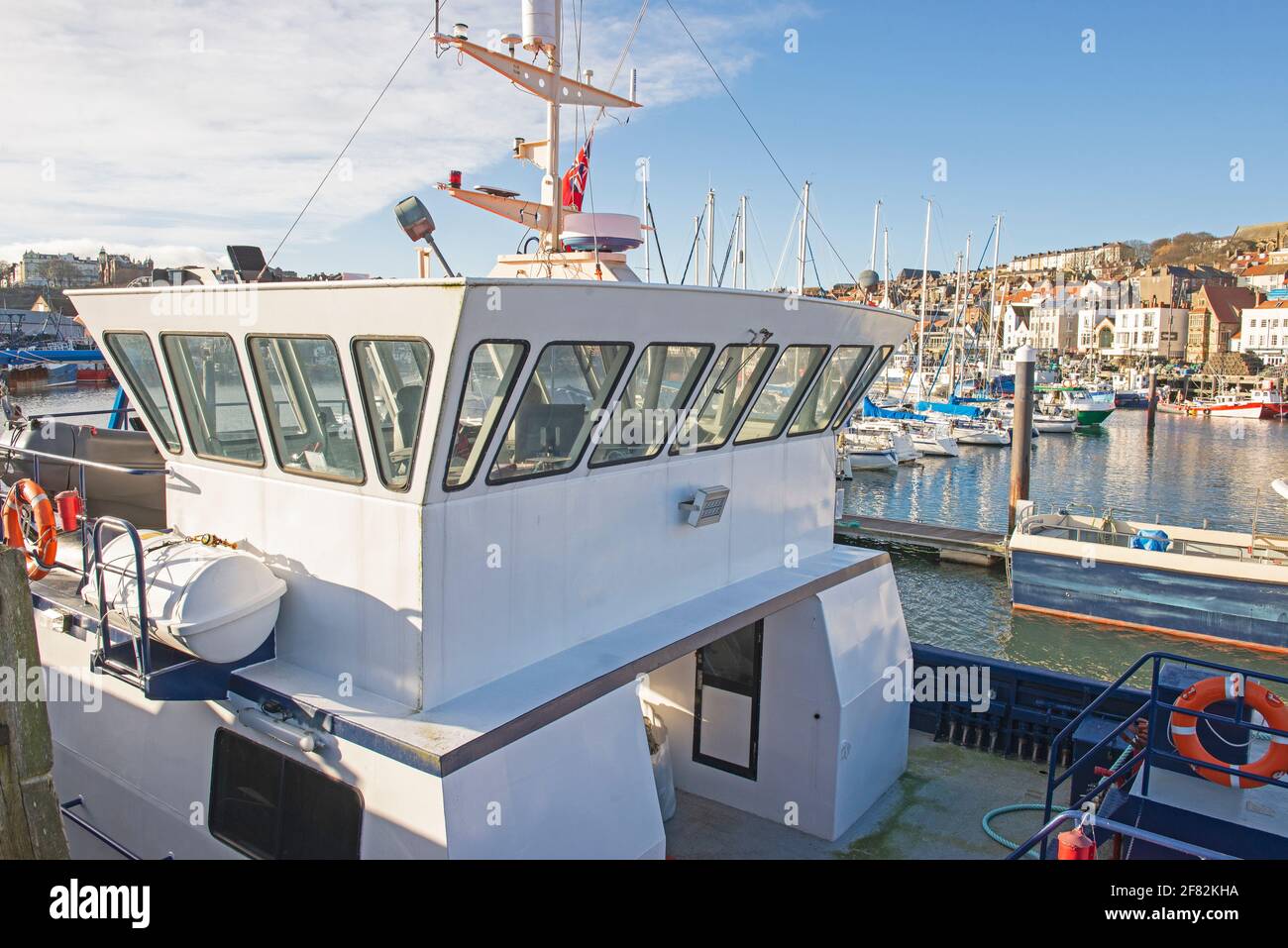 Ship bridge superstructure at coastal seaside town harbor front with ...