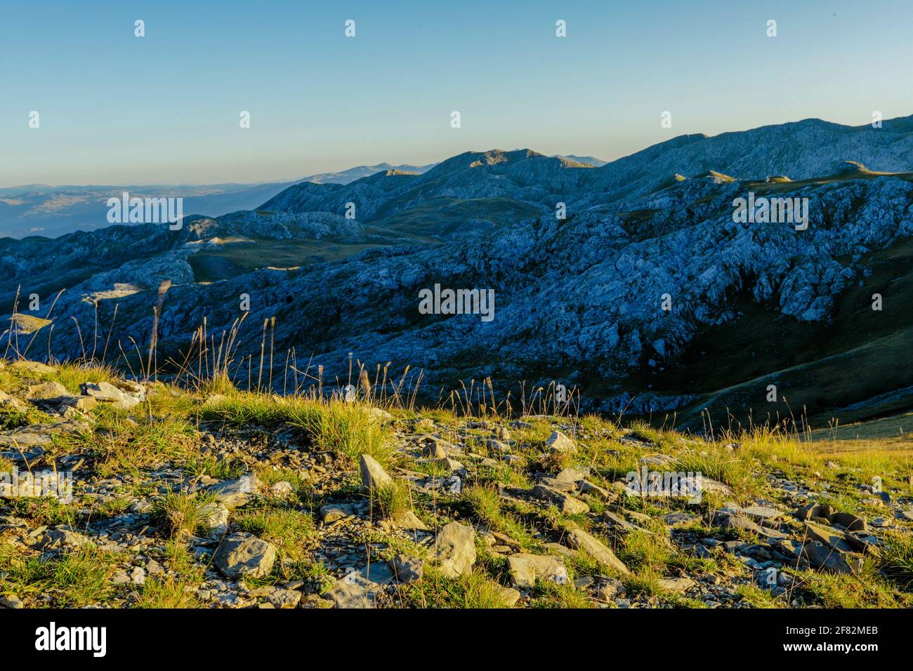 A beautiful landscape of mountains in shadows of sunlight at dawn Stock ...