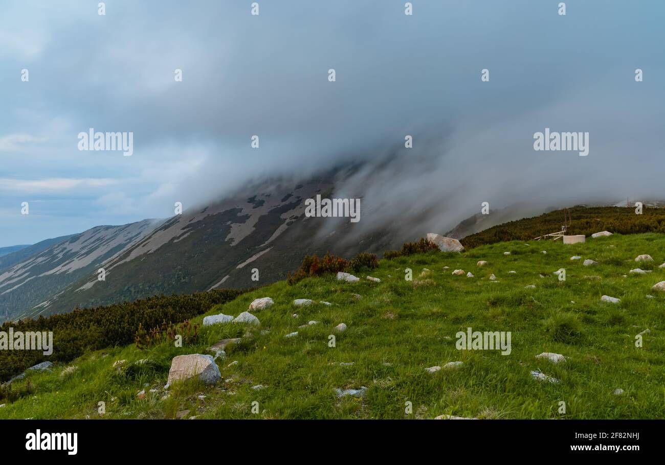 Clouds falling down to Sniezka mountain in Karkonosze Giant Mountains ...