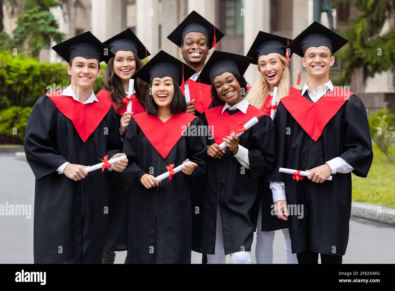 Diverse international students with diplomas celebrating graduation ...