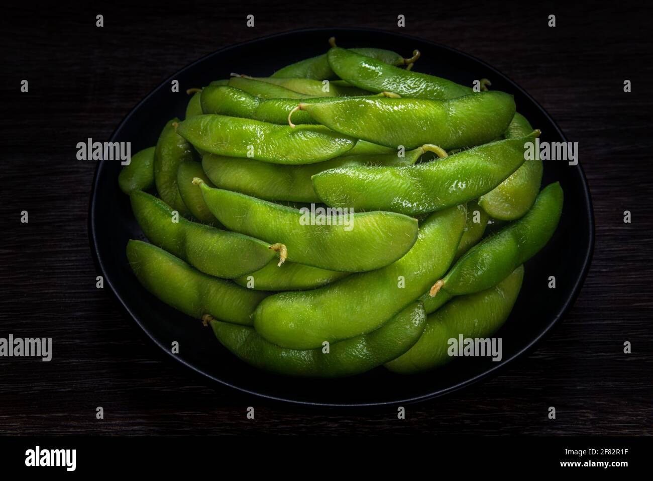 Edamame boiled green soy beans with sea salt on table, traditional ...
