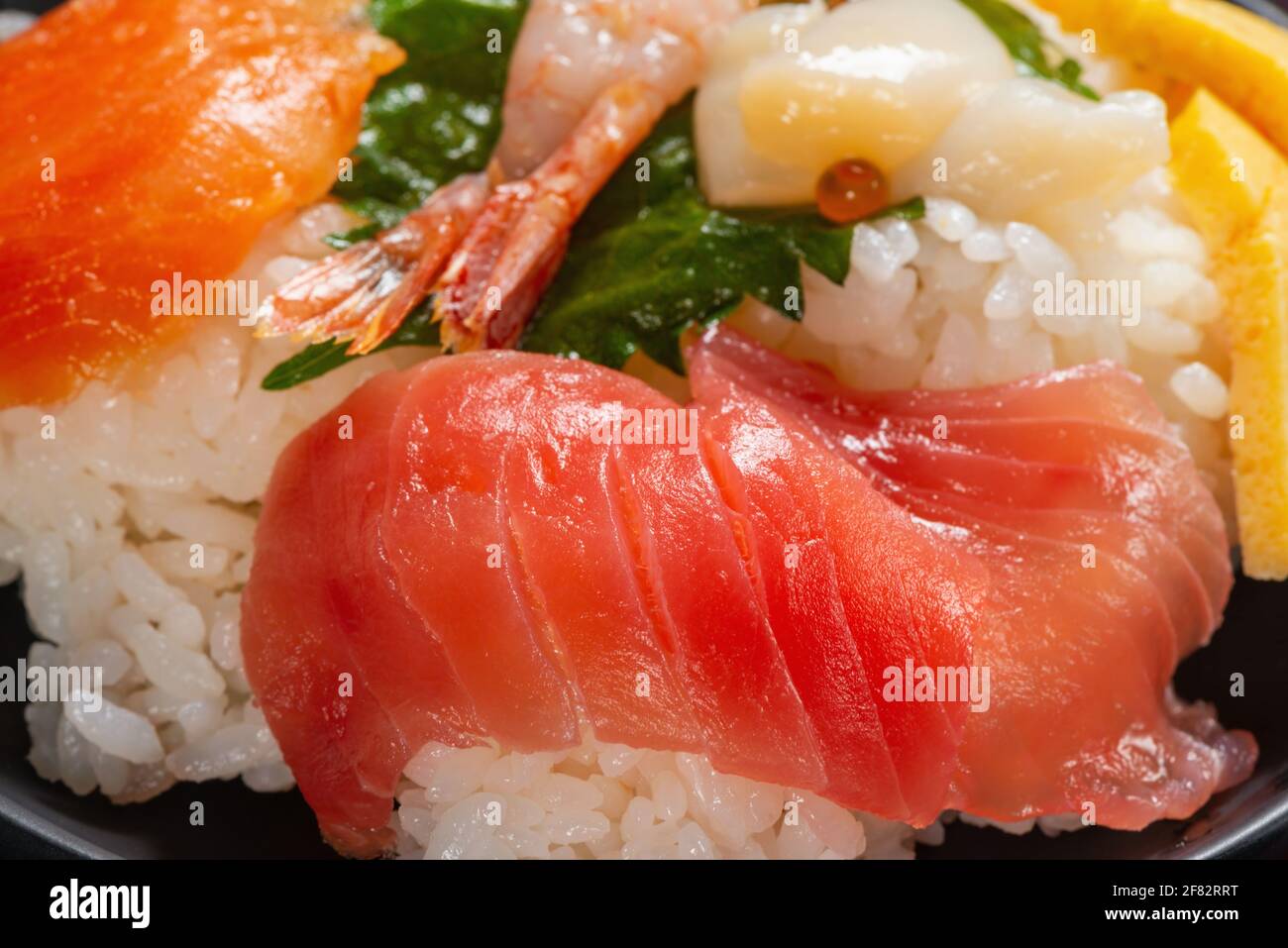 Japanese style setting of donburi with fresh fish and prawns on plate ...