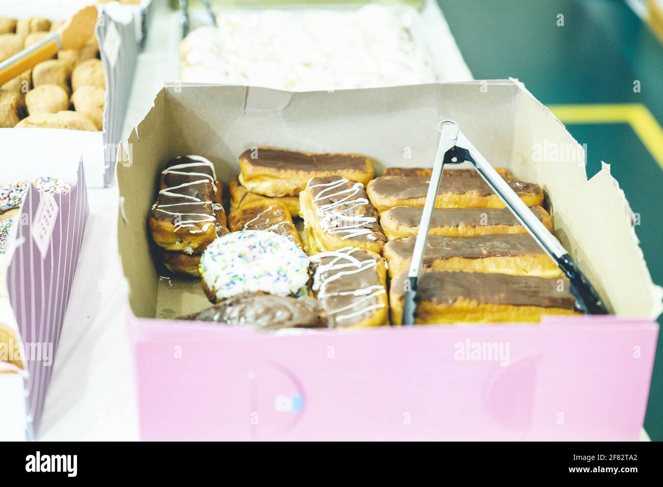 A closeup shot of delicious eclairs in a paper bo Stock Photo - Alamy