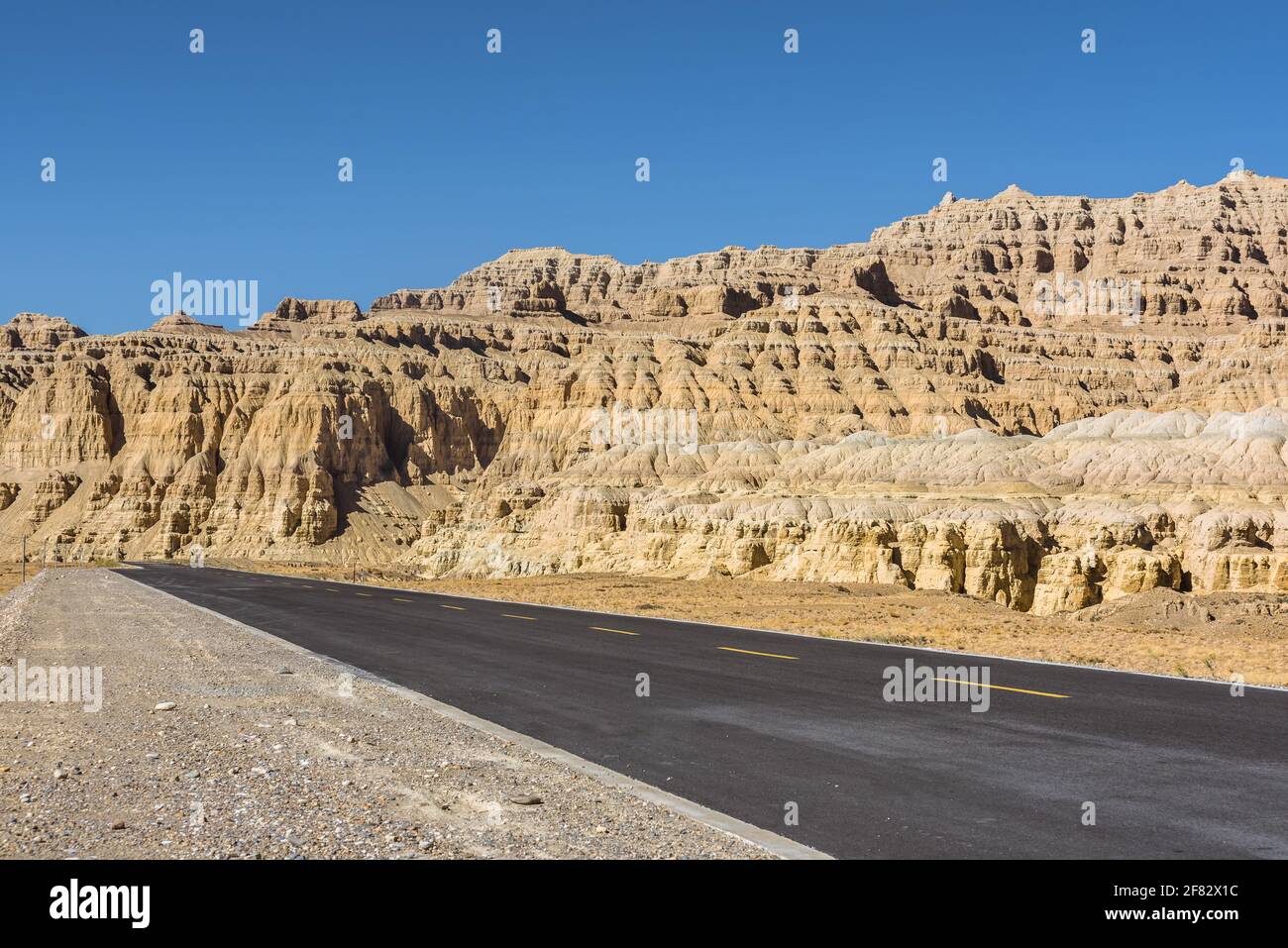 A section of tarmac road in the eroded landscape and rock towers of ...