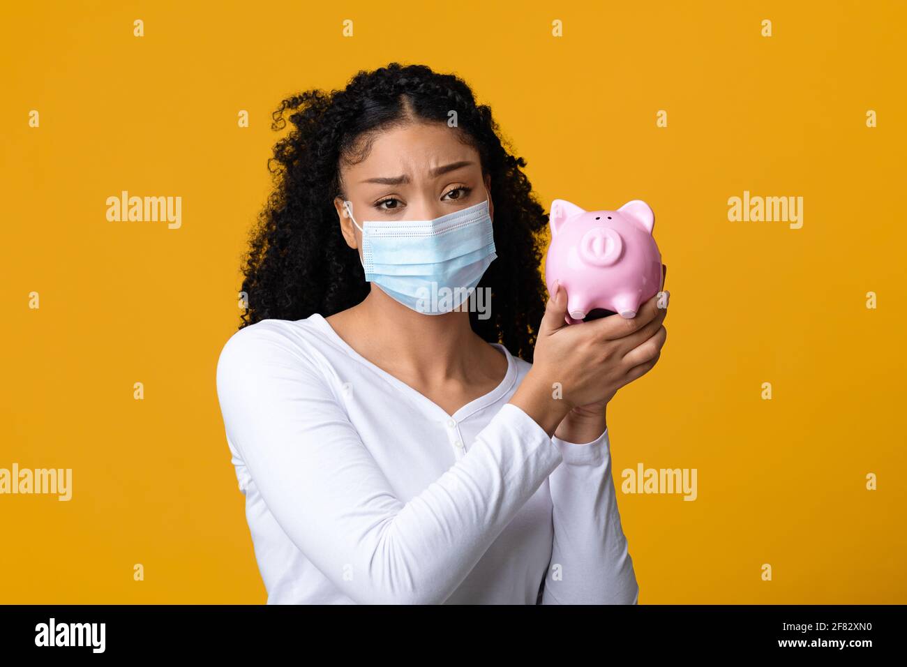 Coronacrisis Concept. Upset black worry woman in medical face mask ...