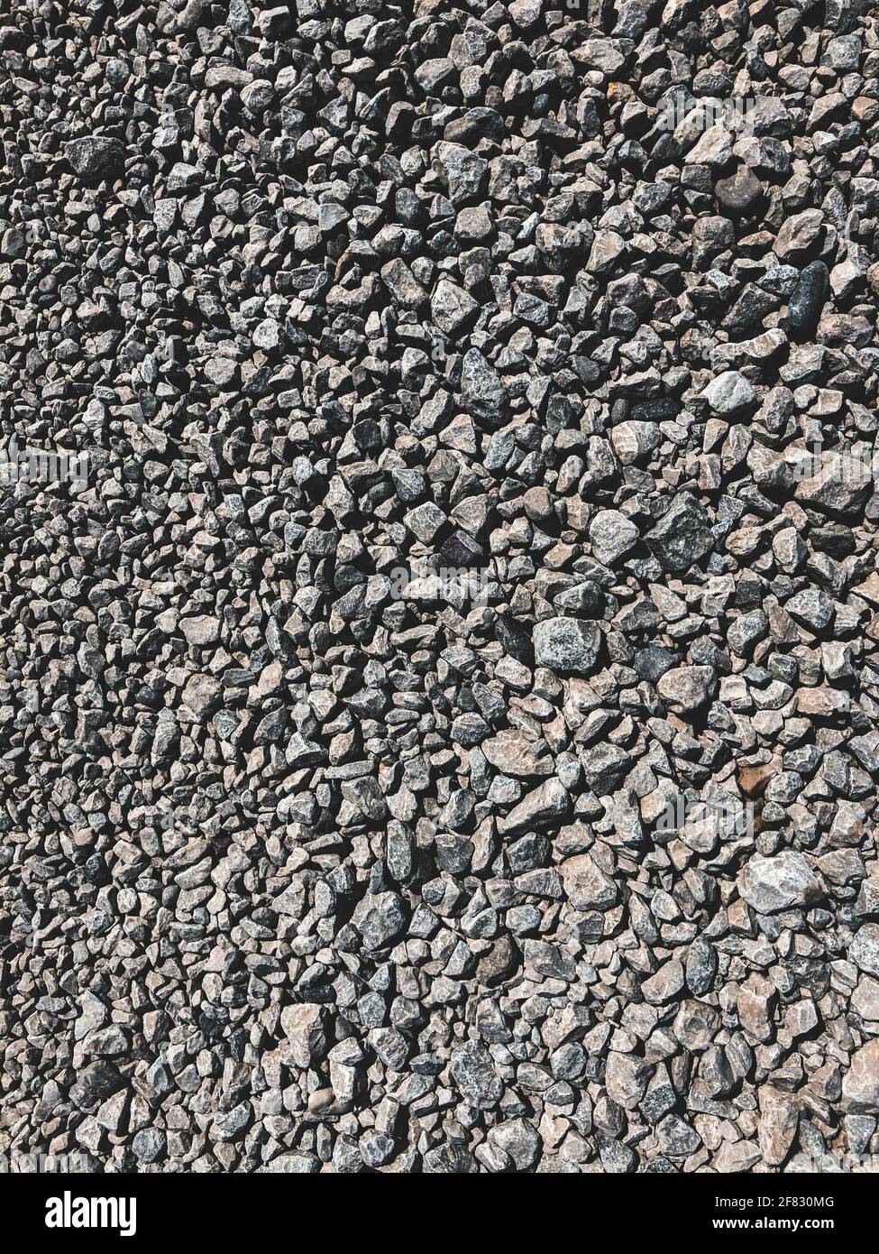 A vertical shot of crushed stones on the ground Stock Photo - Alamy