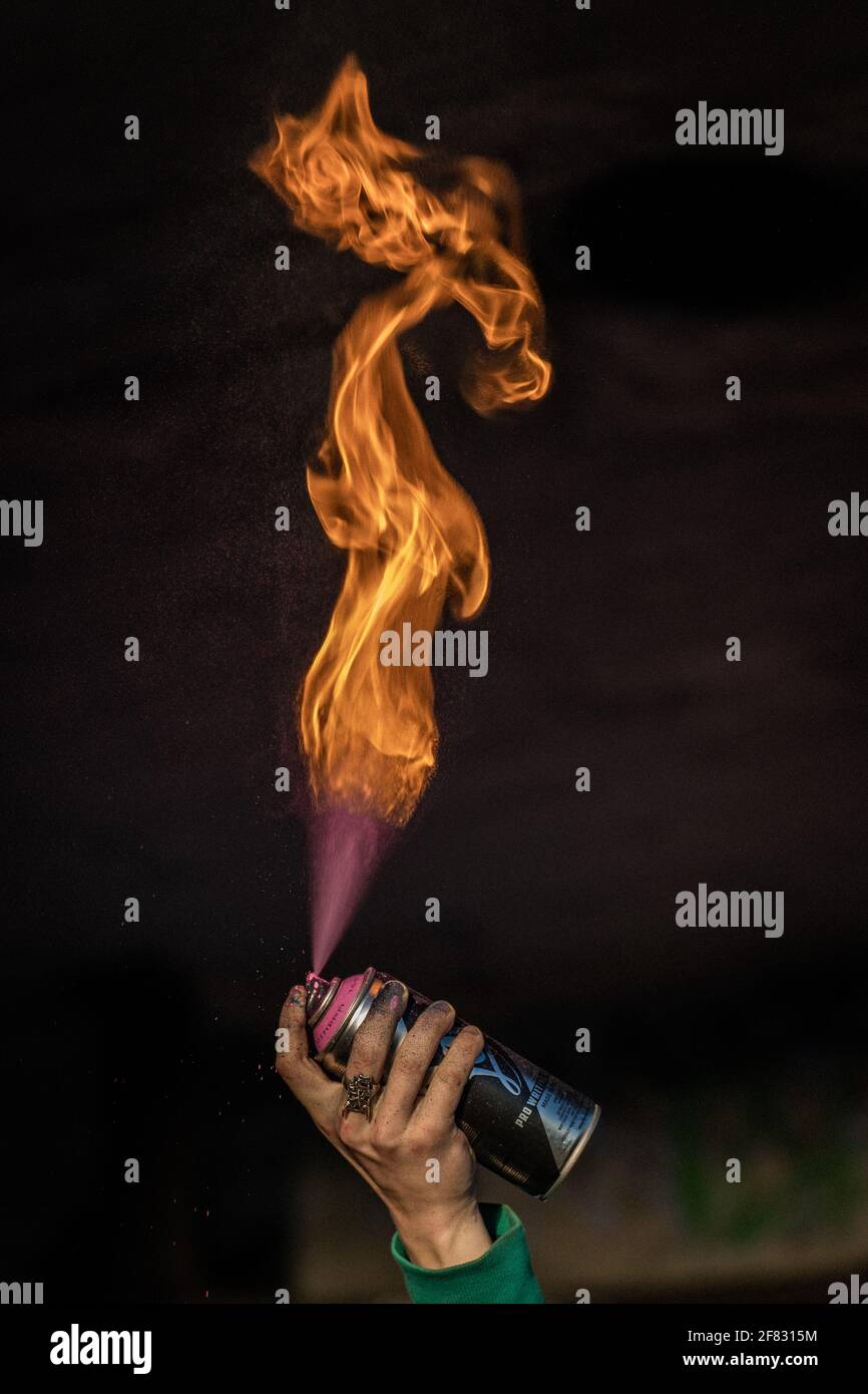 A vertical shot of an old lady's hand doing fire flame from a hand ...