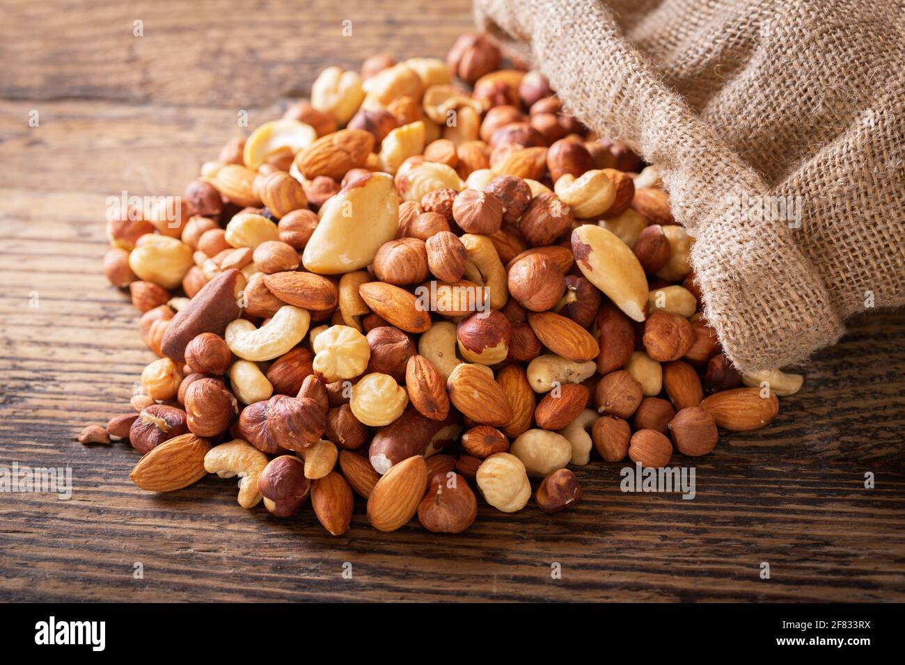 mixed nuts on a wooden table, top view Stock Photo - Alamy