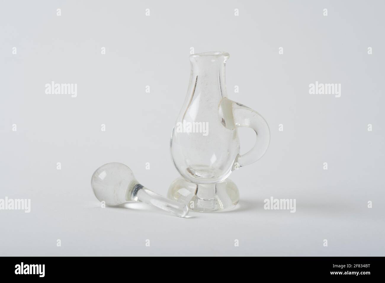 Small, handmade glass container with stopper Stock Photo - Alamy
