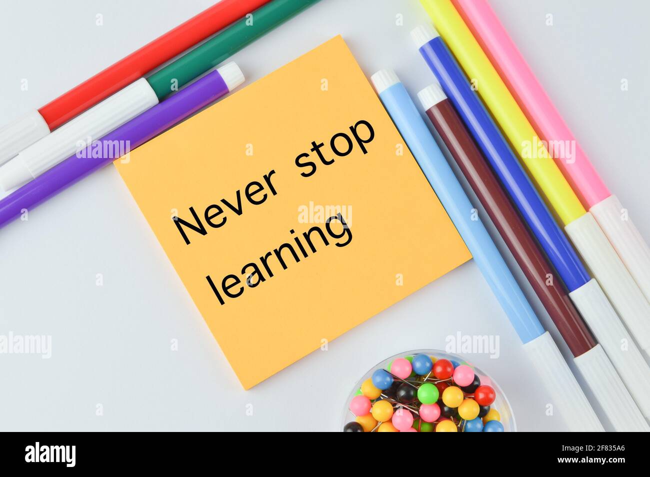 Colorful pen colors and memo note written with NEVER STOP LEARNING ...
