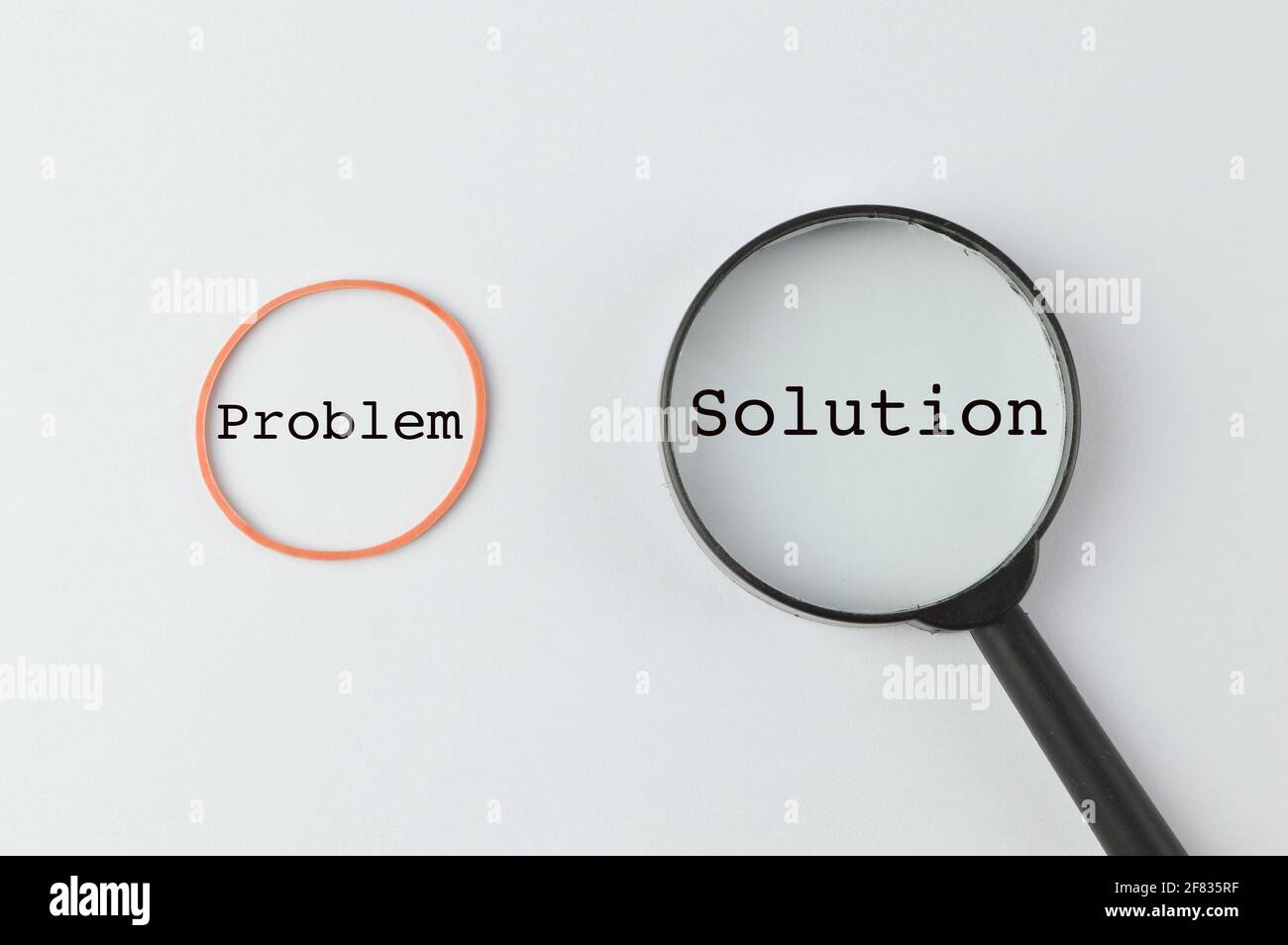 Top view of rubber band and magnifying glass written with PROBLEM and ...