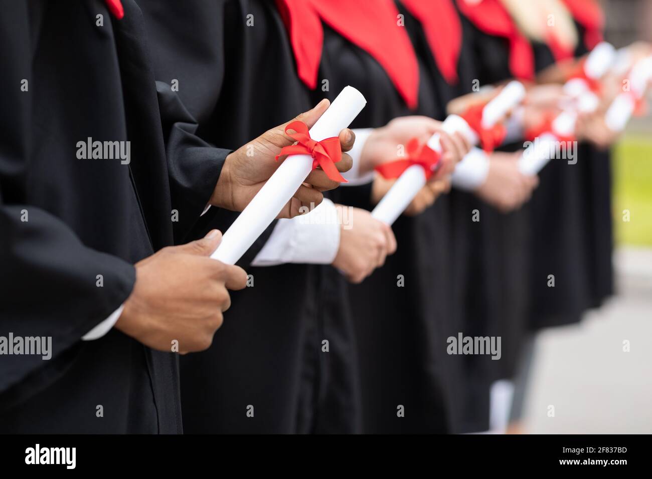 Cropped of international group of graduates holding diplomas Stock ...
