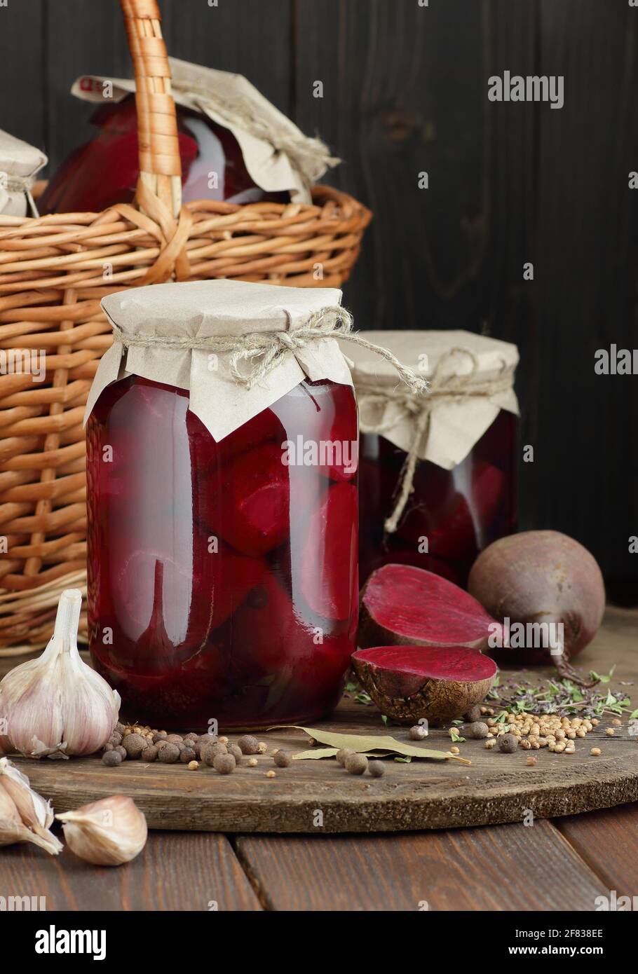 Canned beetroot in glass jars on rustic wooden background, closeup ...