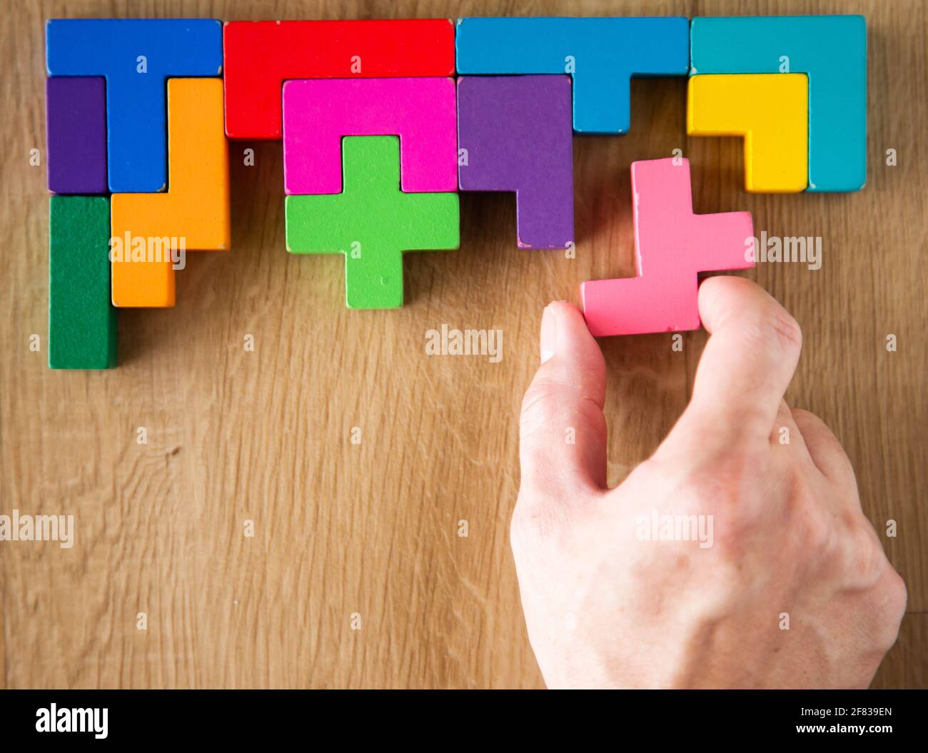 hand put wooden blocks arranging for finishing task Stock Photo - Alamy