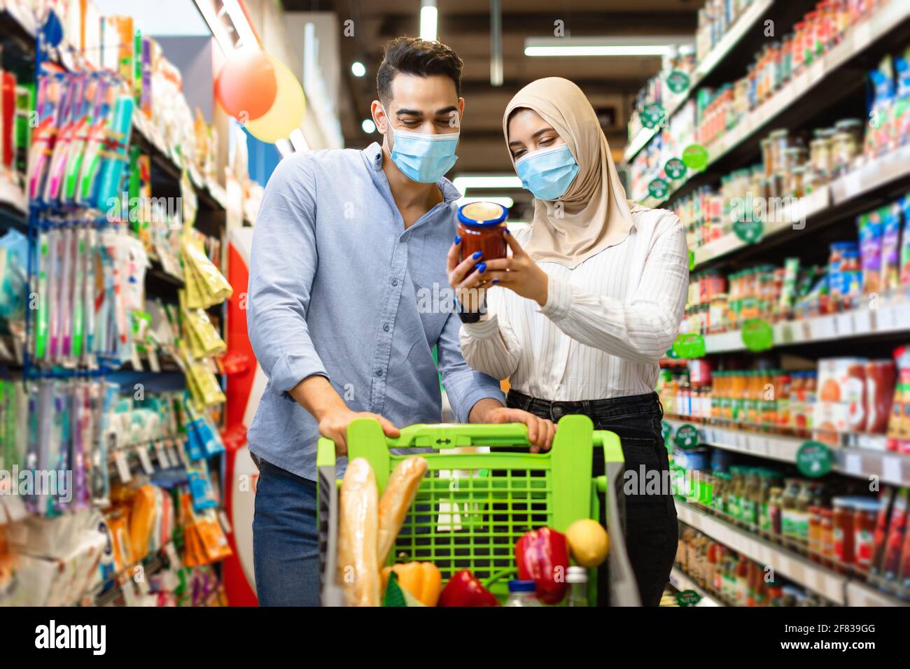 Muslim Family Doing Grocery Shopping Buying Food In Supermarket Stock ...