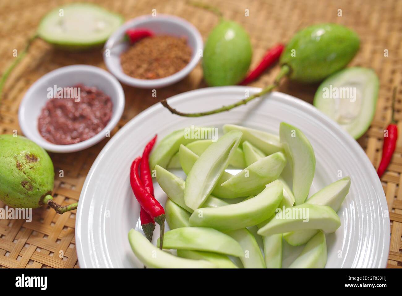 Cut green mango with shrimp paste on bamboo tray Stock Photo - Alamy