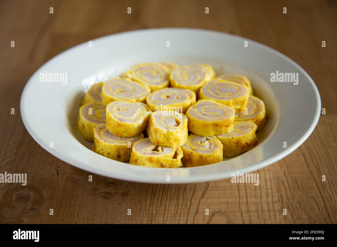 egg roll with fish paste on wooden background Stock Photo - Alamy