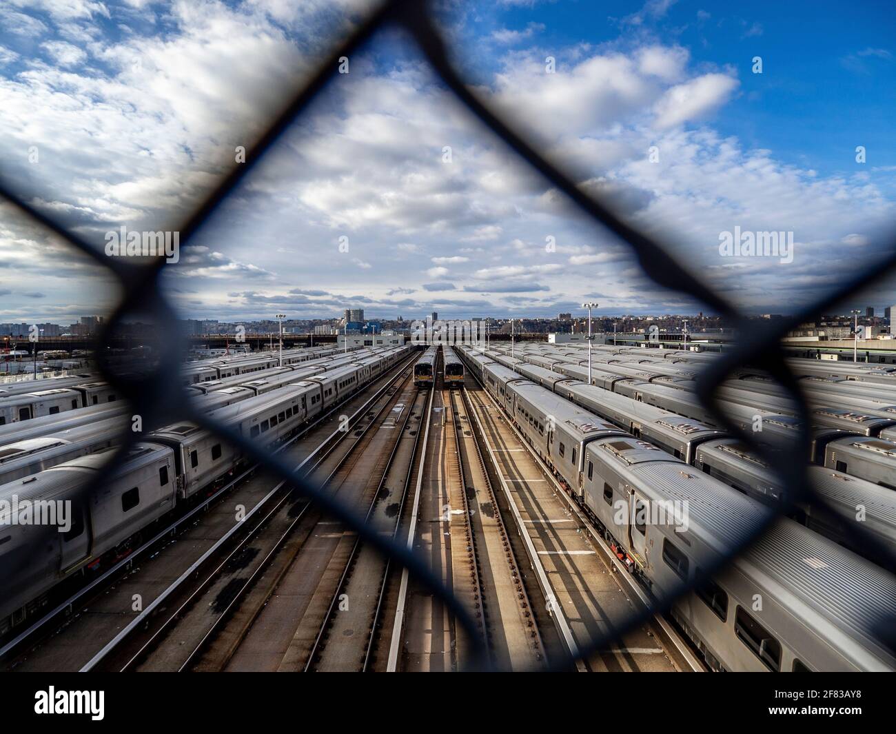 vanishing point view of some train in a city from a fence Stock Photo ...