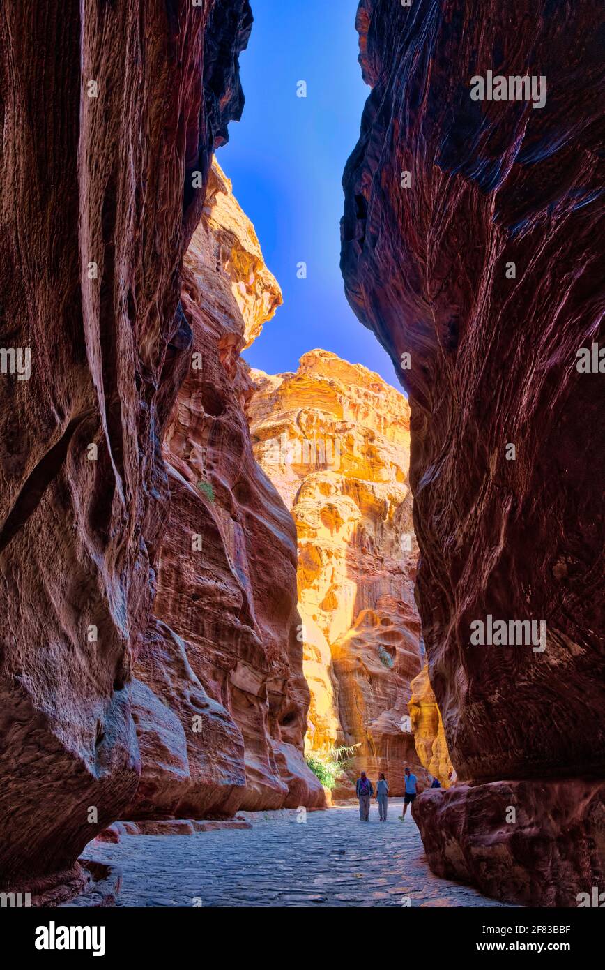 Blue skies and red rocks tower over the pathways and roads in the ...