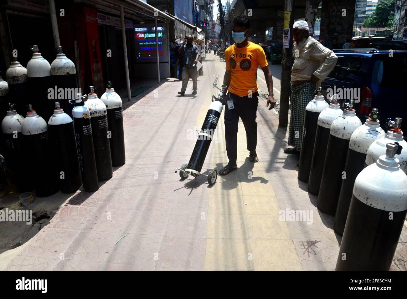 A worker set up oxygen cylinder at a store as cylinders demand rise up ...