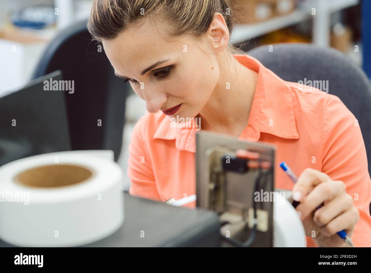 Woman working on label printing machine Stock Photo - Alamy