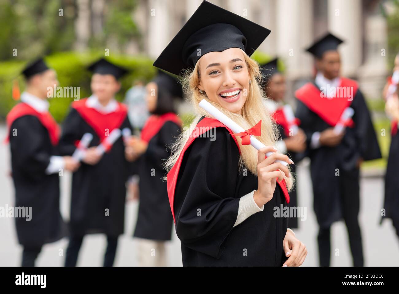 Cute blonde lady student having graduation party Stock Photo - Alamy