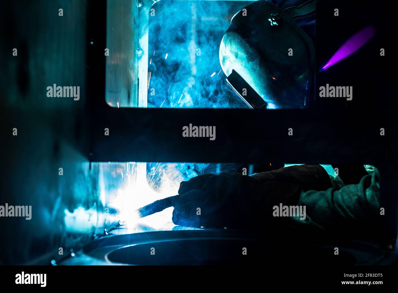 Welder working in industrial metal factory Stock Photo - Alamy