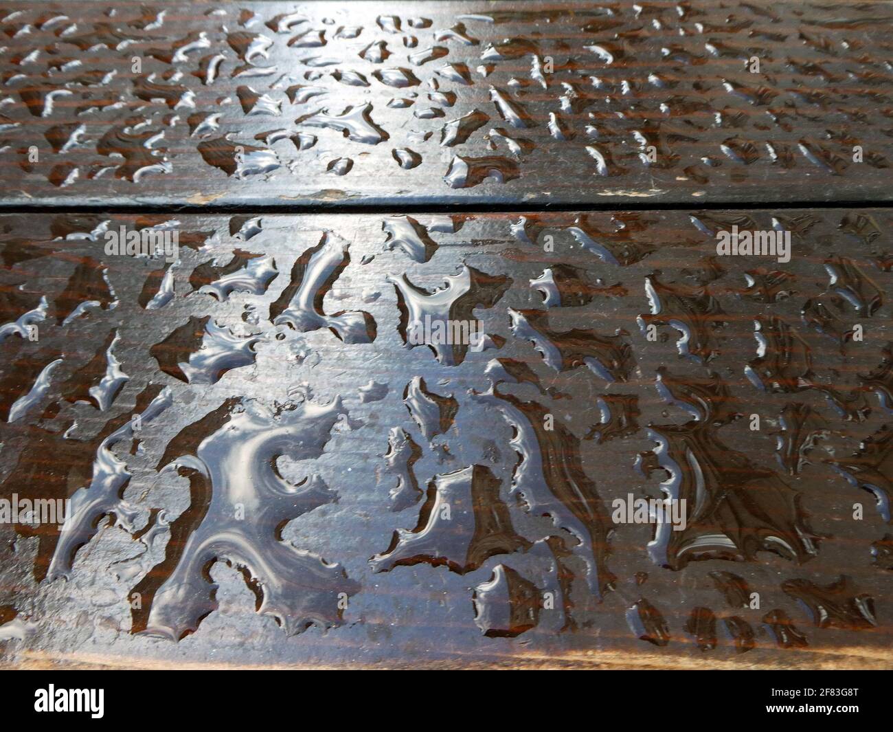 A closeup shot of a wet wooden table surface after the rain Stock Photo ...