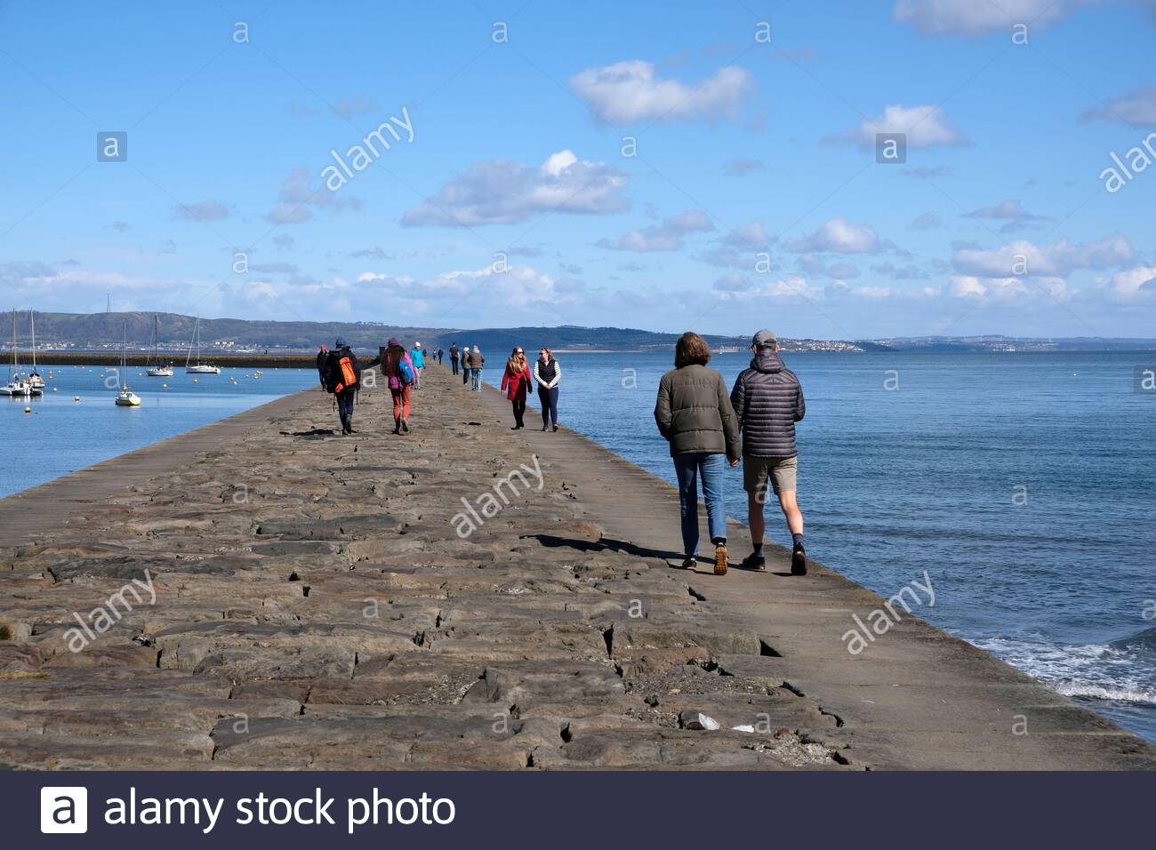 People at Granton harbour and breakwater with a view over the Forth ...