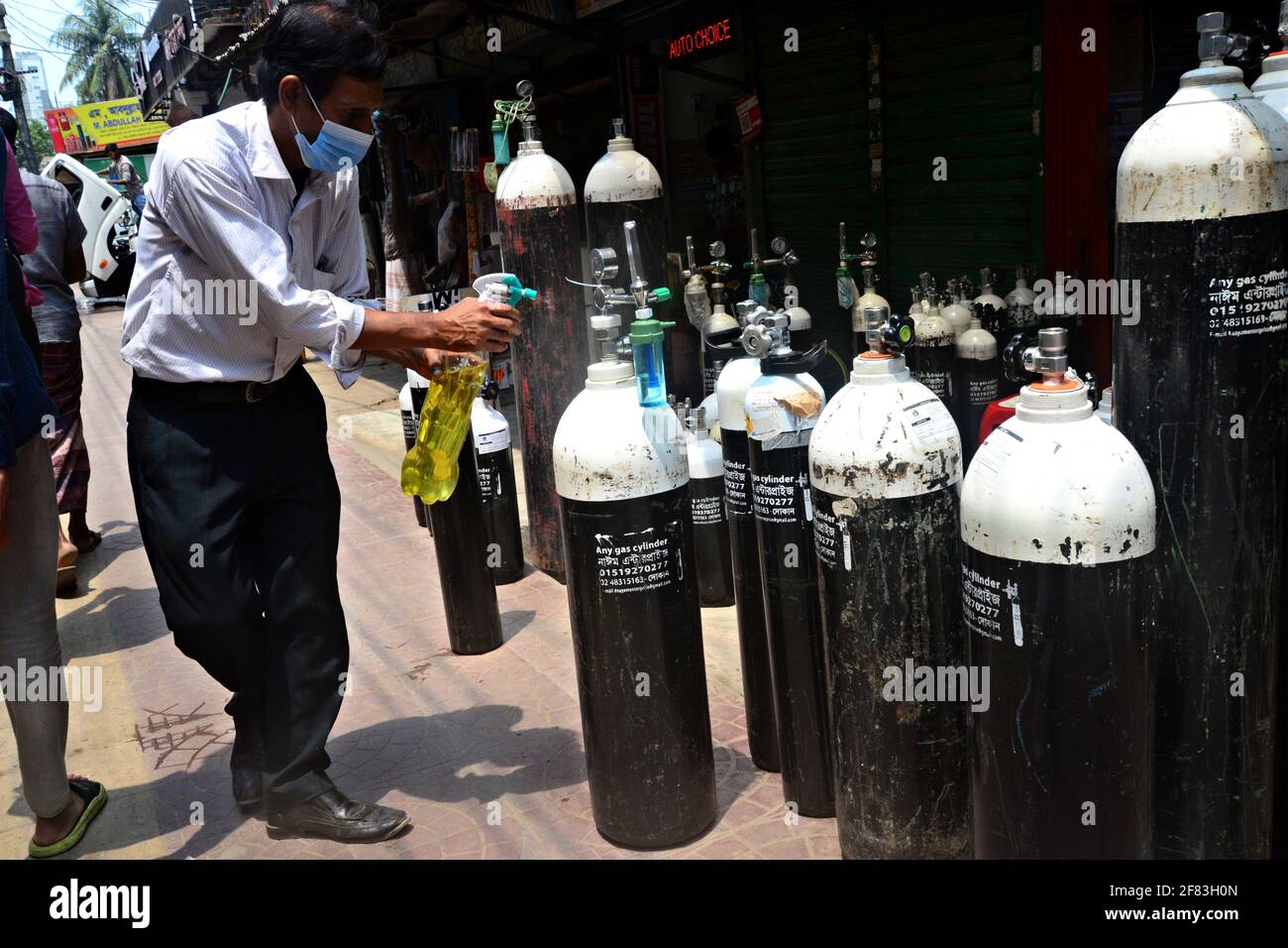 A worker set up oxygen cylinder at a store as cylinders demand rise up ...
