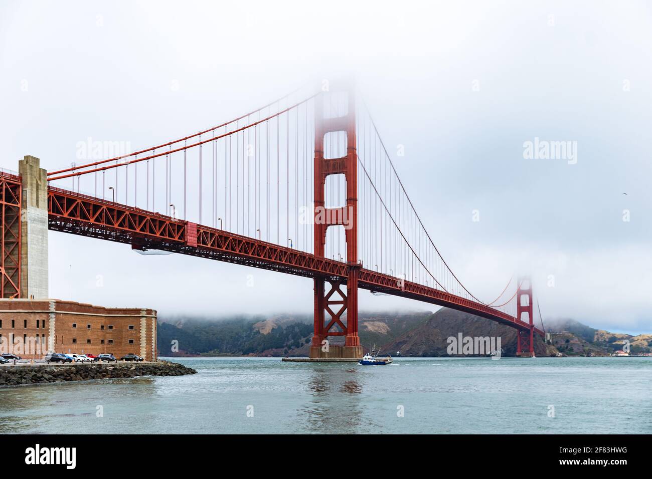 famous red suspension bridge in a city with low clouds Stock Photo - Alamy